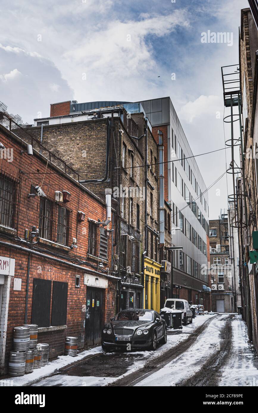 Narrow industrial street or alley in the inner city hilights how a ...