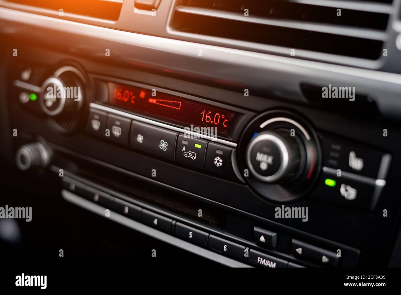 Temperature display on the car's climate control panel in a blurry ...