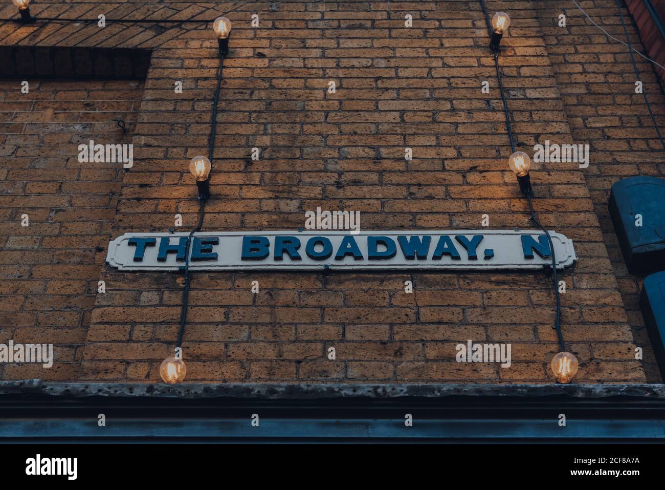 Street name sign amongst a string of lights on The Broadway, Crouch End ...
