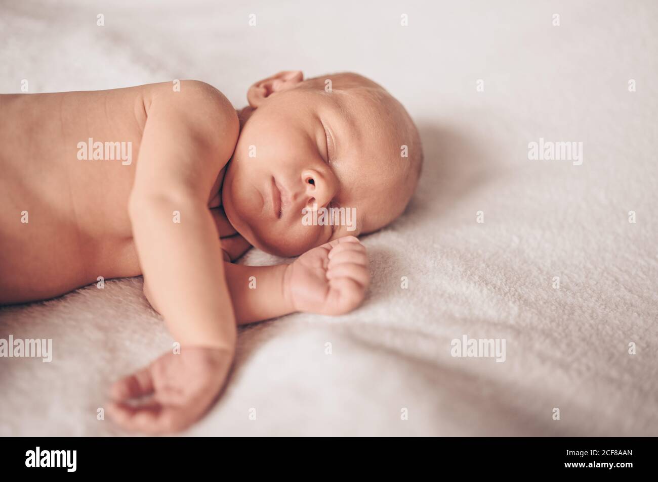 Cute emotional newborn funny little baby boy sleeping in crib. Baby ...