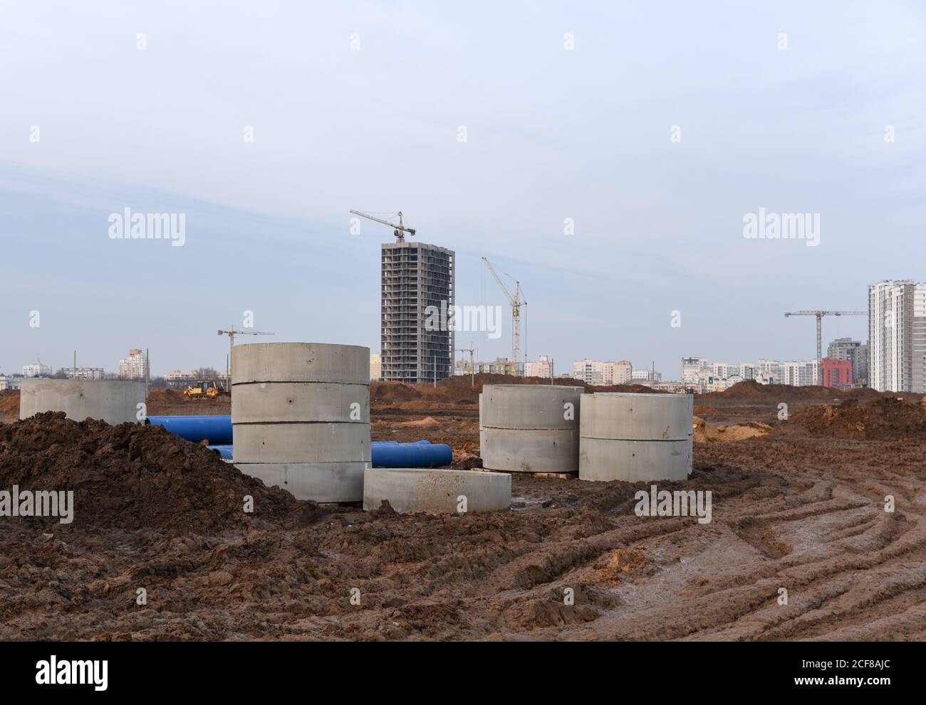 Installation of concrete sewer wells in the ground at the construction ...