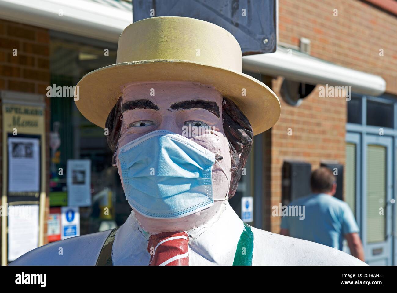 Figure of butcher,outside shop, fitted with face-mask, England UK Stock ...