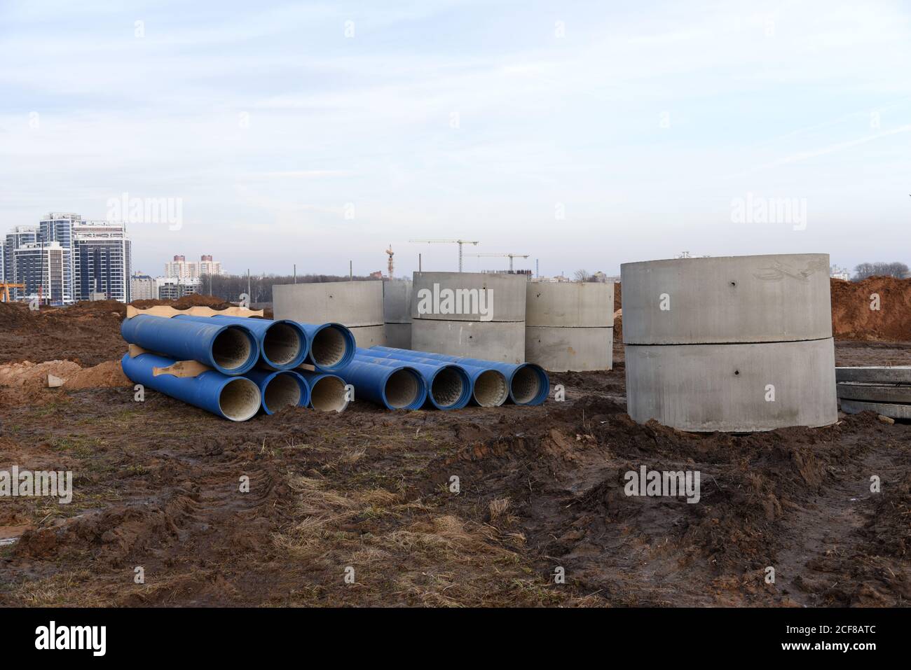 Installation of concrete sewer wells in the ground at the construction ...