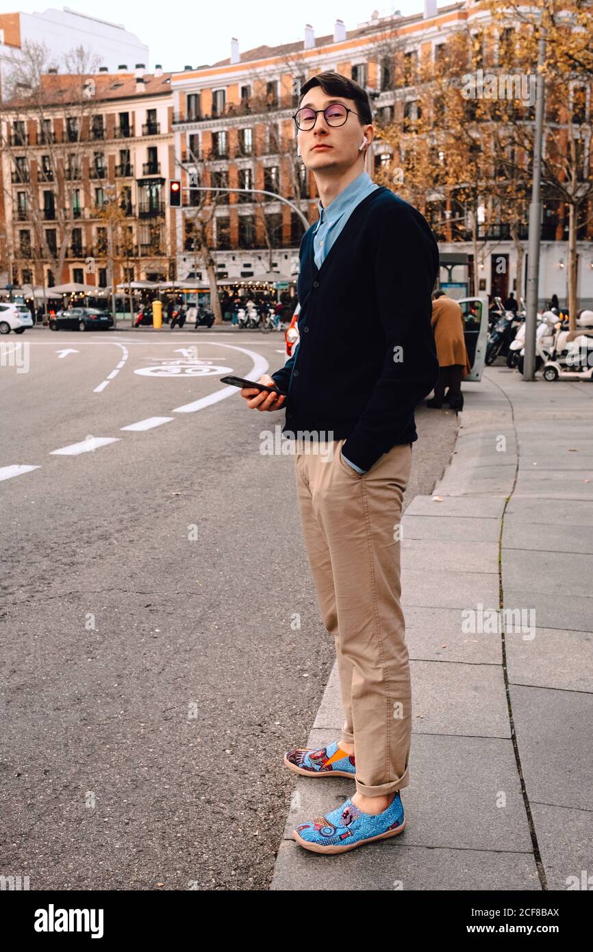 Full body of young confident trendy male in fashionable outfit and ...