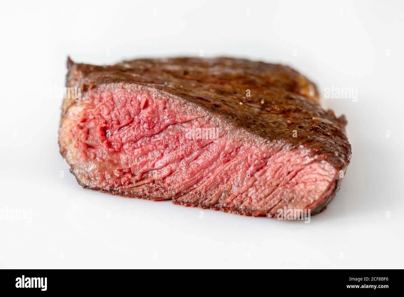 Cross section of rib eye steak on white background Stock Photo - Alamy