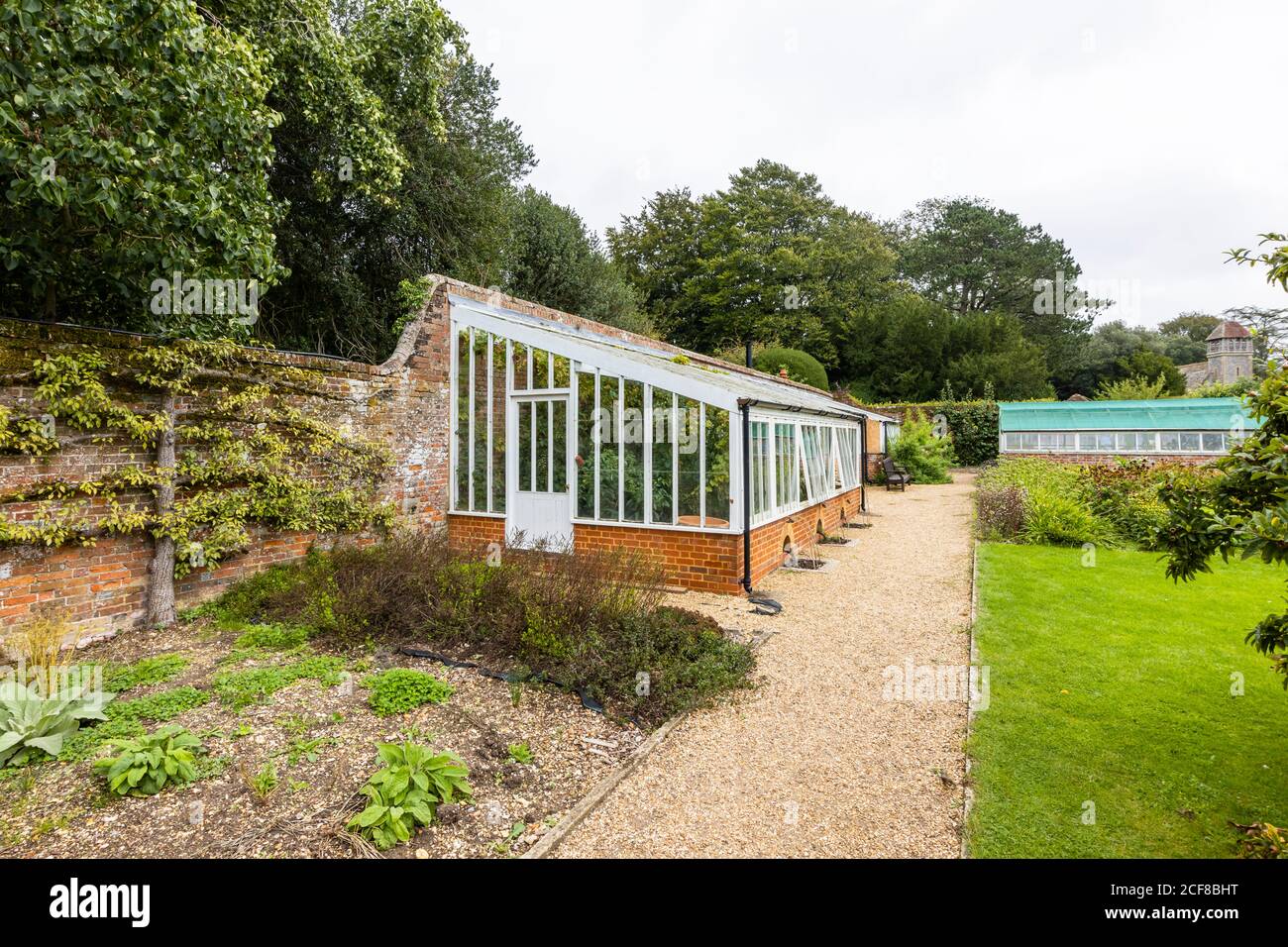 View of a typical old-fashioned lean-to greenhouse in the walled garden ...