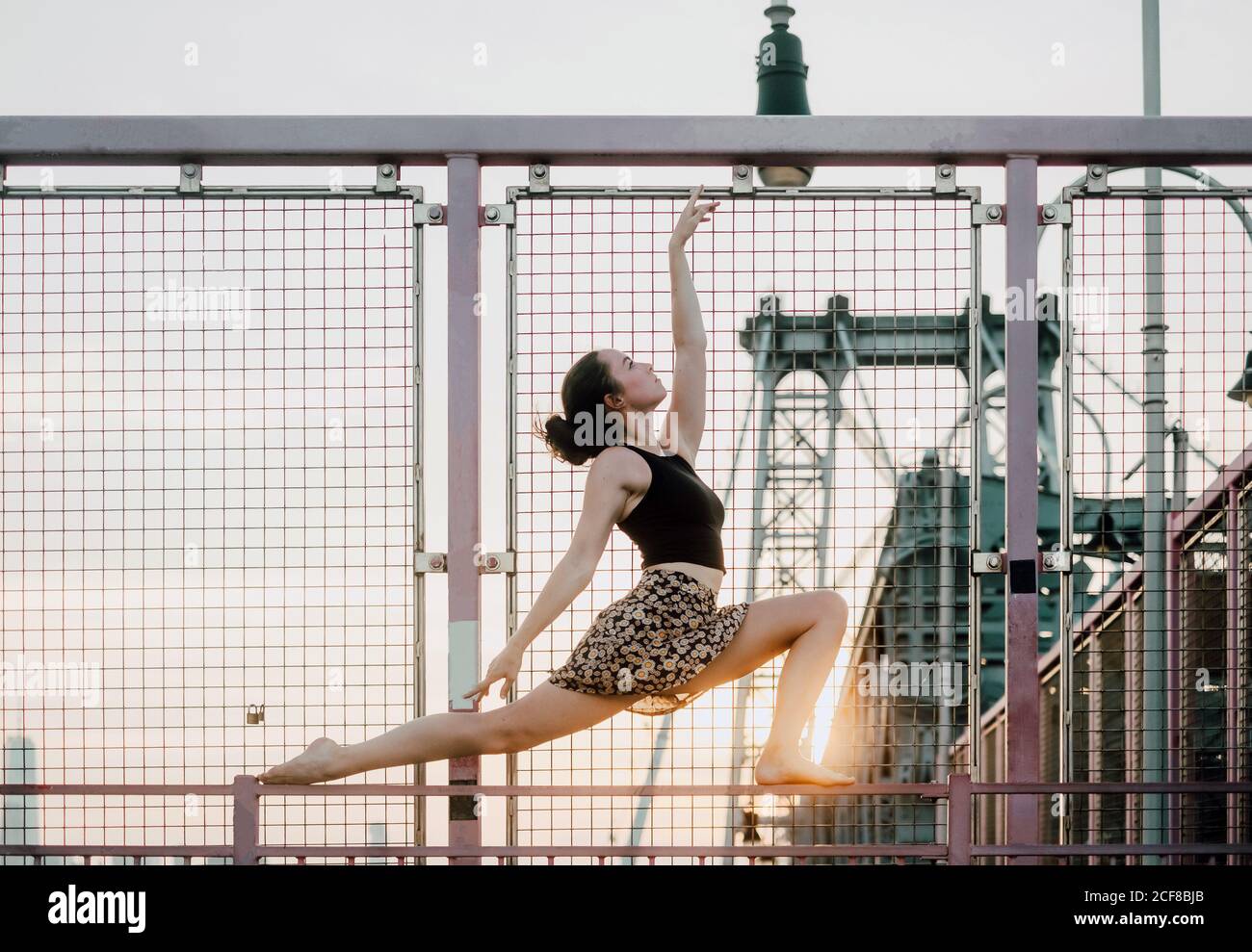 Low angle side view of serene female wearing summer outfit doing yoga ...
