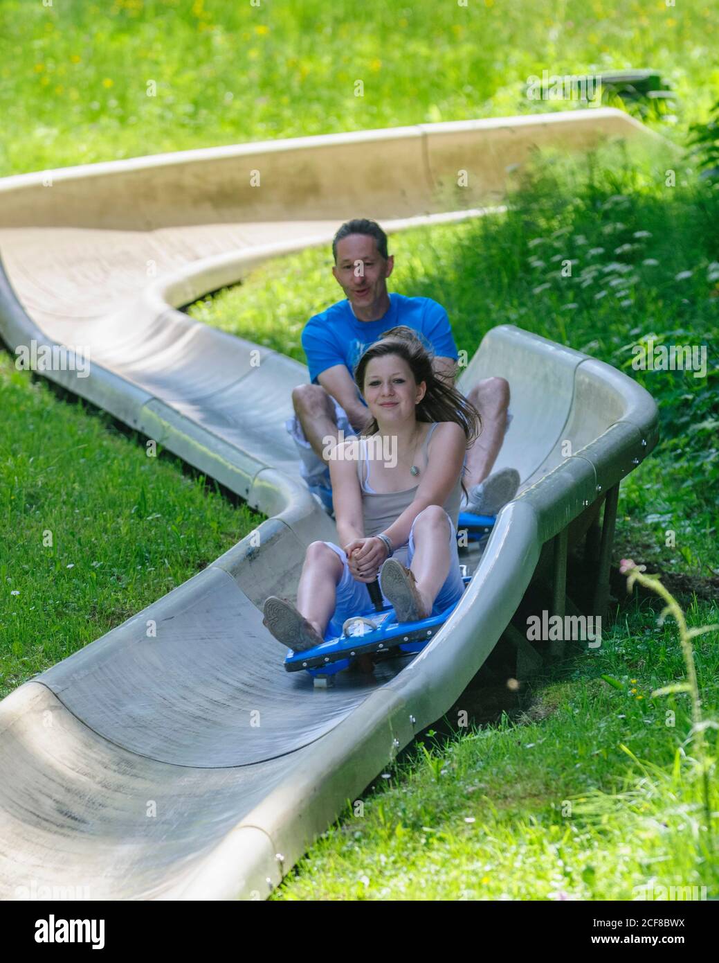 Family on summer toboggan run Stock Photo - Alamy