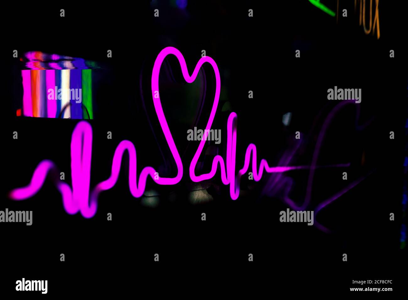 Neon heart display on the window of a store Stock Photo - Alamy
