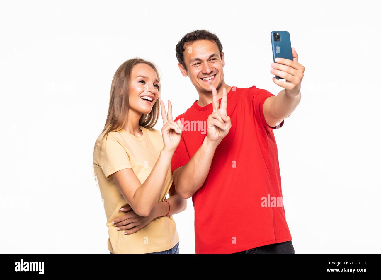 Young couple making a selfie or video call together with a mobile phone ...