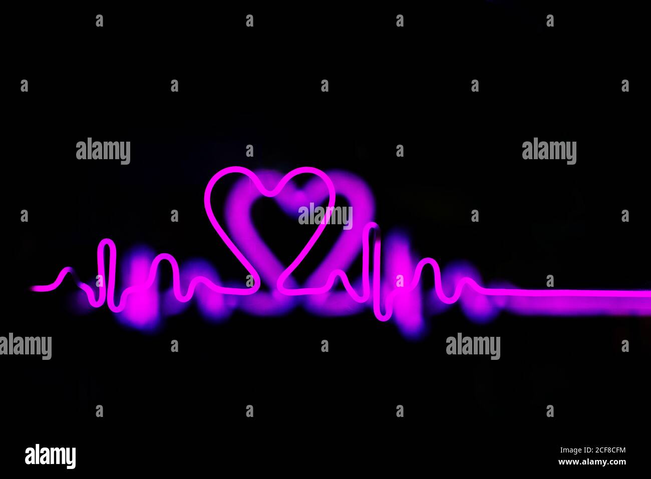 Neon heart display on the window of a store Stock Photo - Alamy