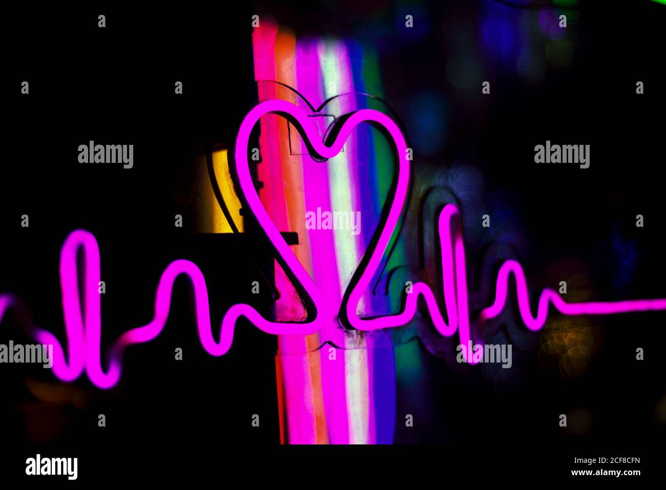 Neon heart display on the window of a store Stock Photo - Alamy