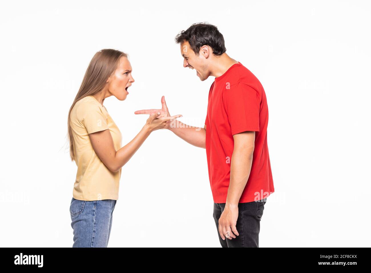 Young couple having argument on white background Stock Photo - Alamy