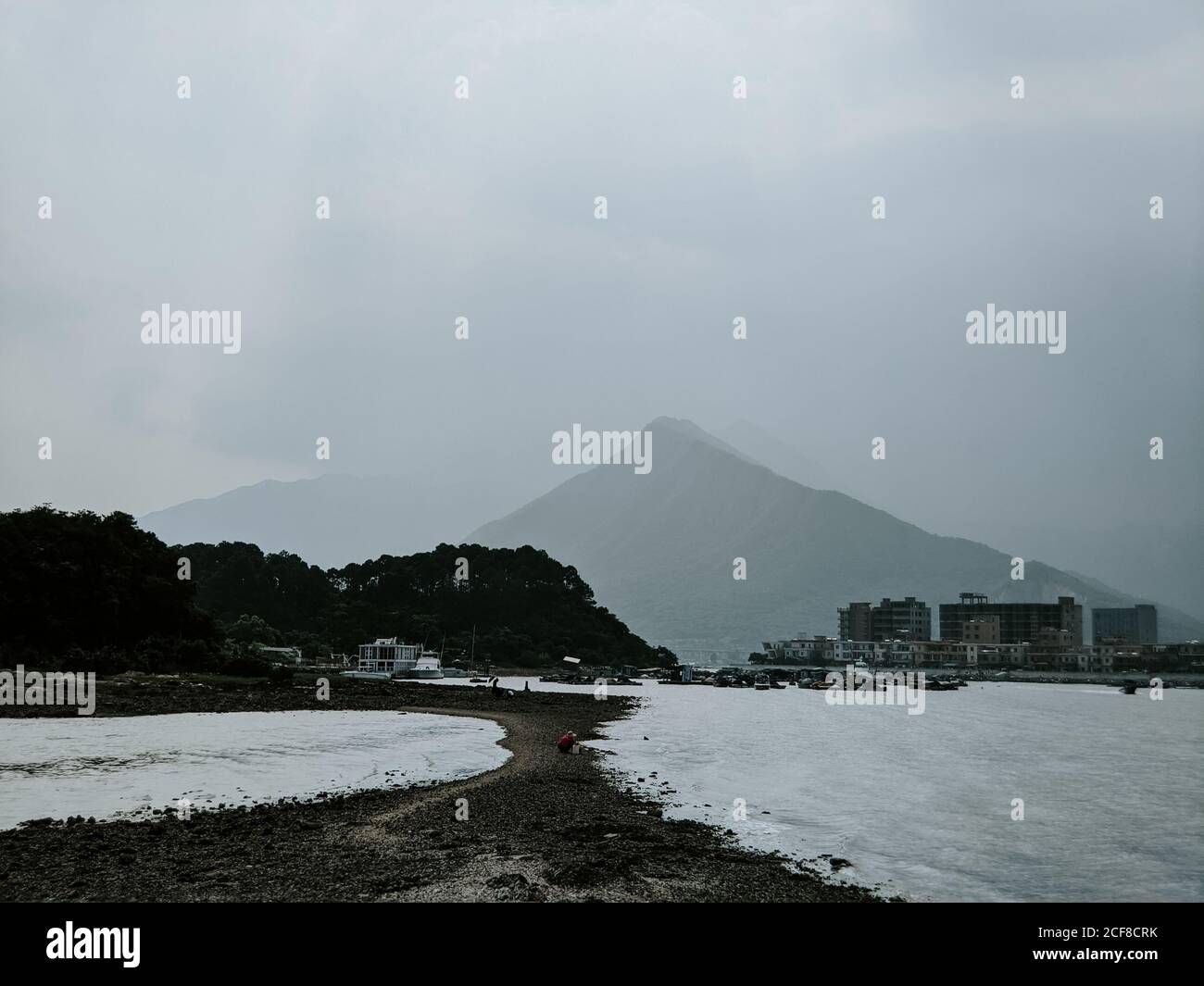 Grey scenery of a beautiful beach in a foggy weather Stock Photo - Alamy