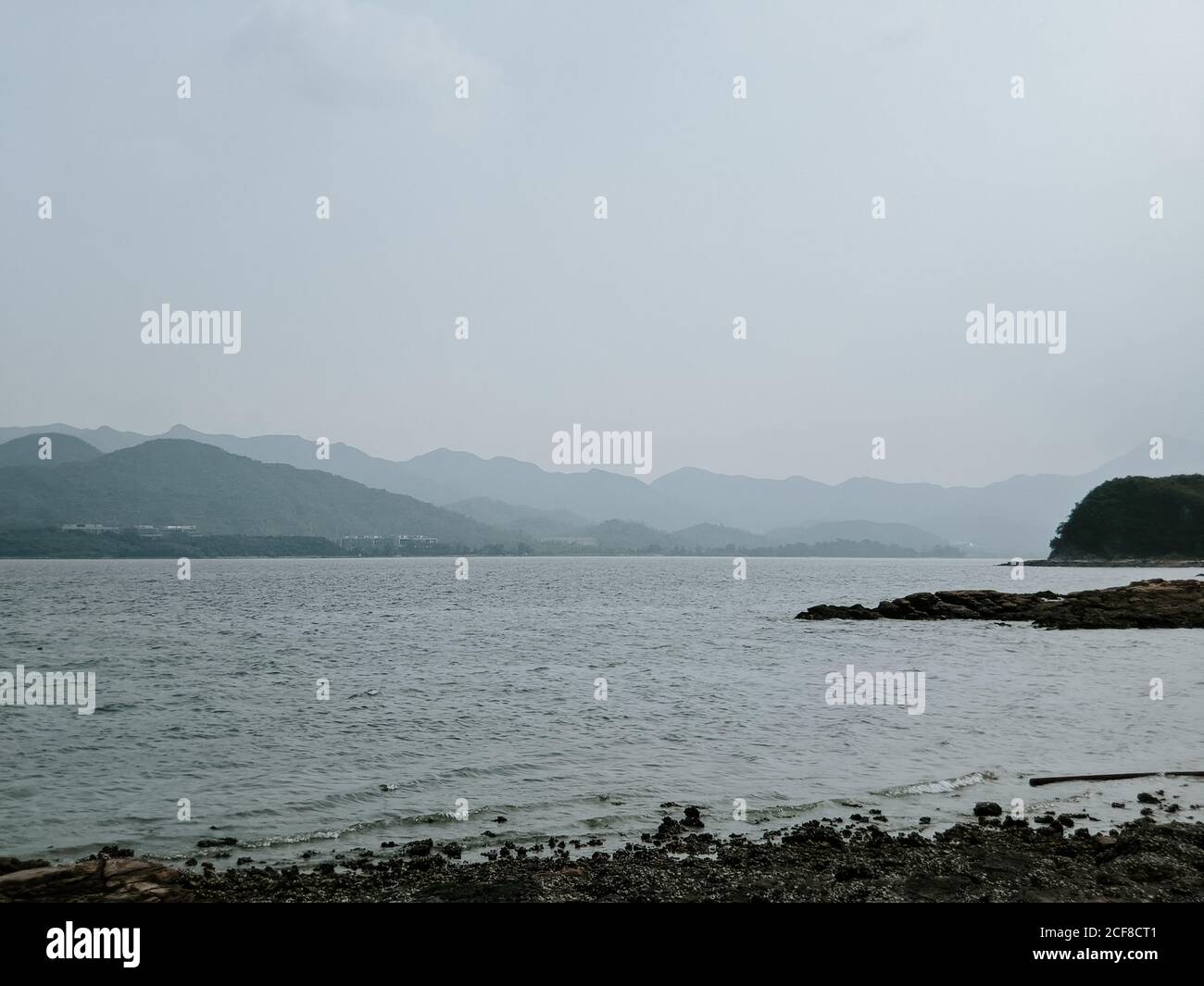 Grey scenery of a beautiful beach in a foggy weather Stock Photo - Alamy