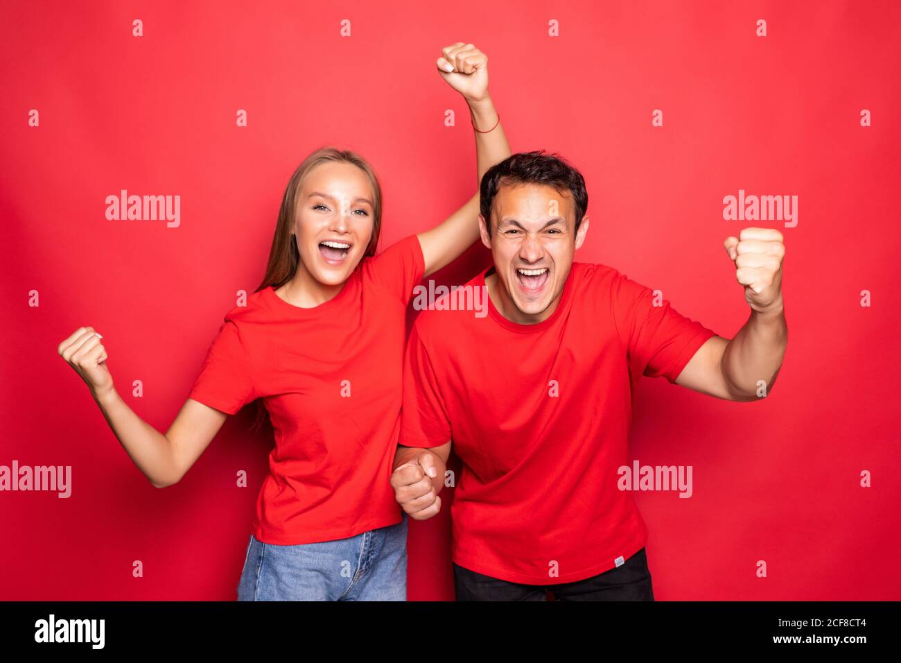 happy couple won emotionally celebrating win on red background Stock ...