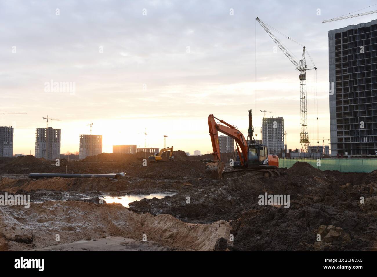 Large tracked excavator at construction site on the background sunset ...