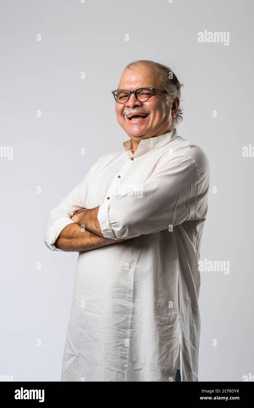Portrait of cheerful Indian retired old man wears white kurta, pointing ...