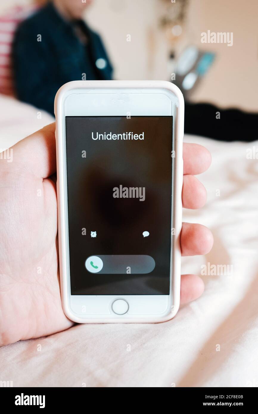 Crop person showing to camera phone screen with incoming call of ...