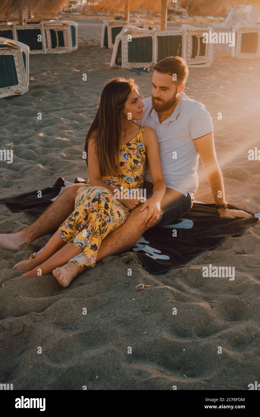 Young people falling in love bonding in seaside in romantic sunset ...