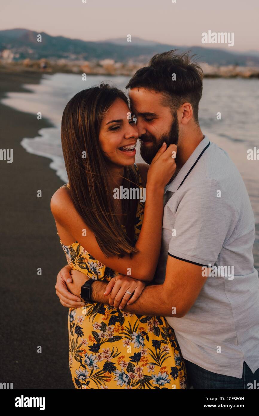 Amorous man hugging Woman while charming lady looking gently touching ...