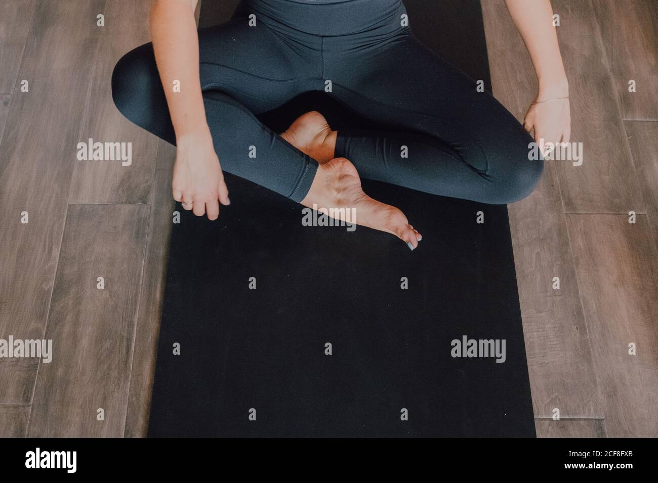 Diligent cropped unrecognizable barefooted Woman in sportswear ...