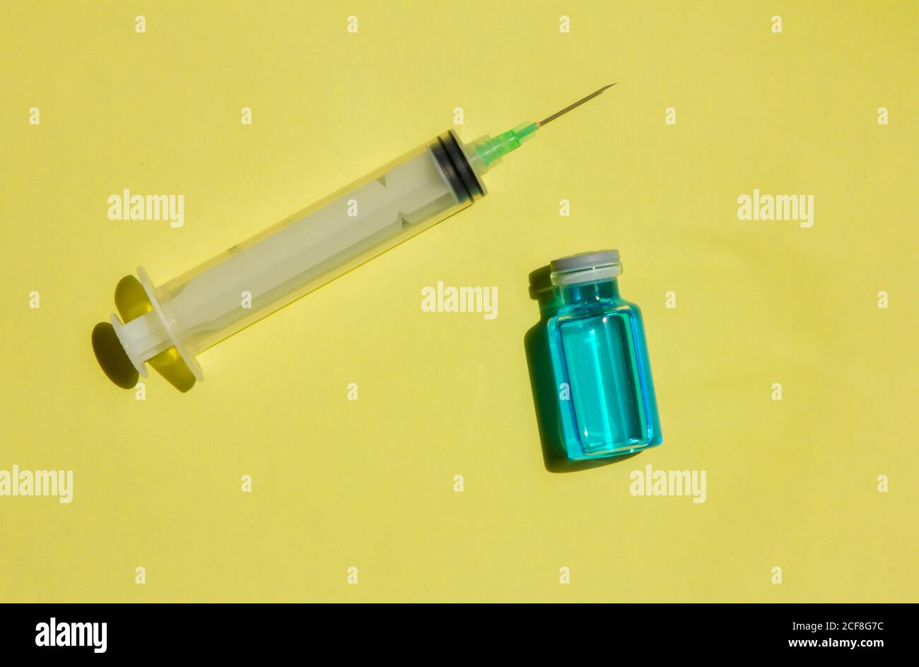 Illustration of a syringe and an ampule on a yellow background Stock ...