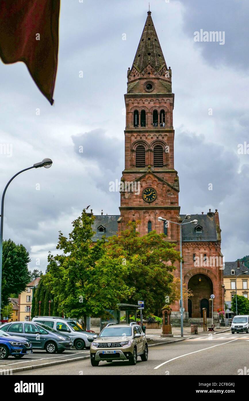 Big red sandstone church with tower, ihe old town of Munster, in the ...