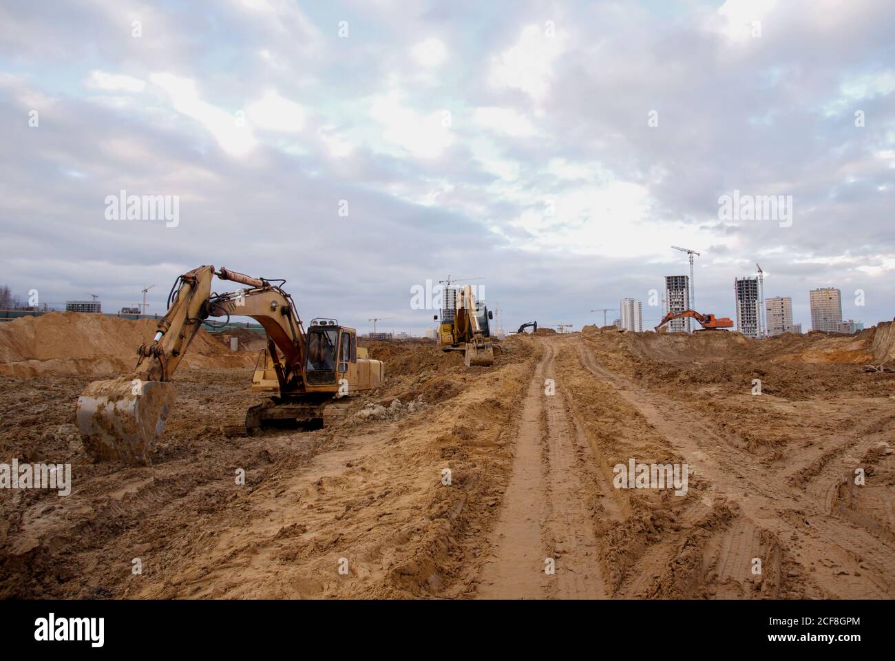 Group of the excavators for dig ground trenching at a construction site ...