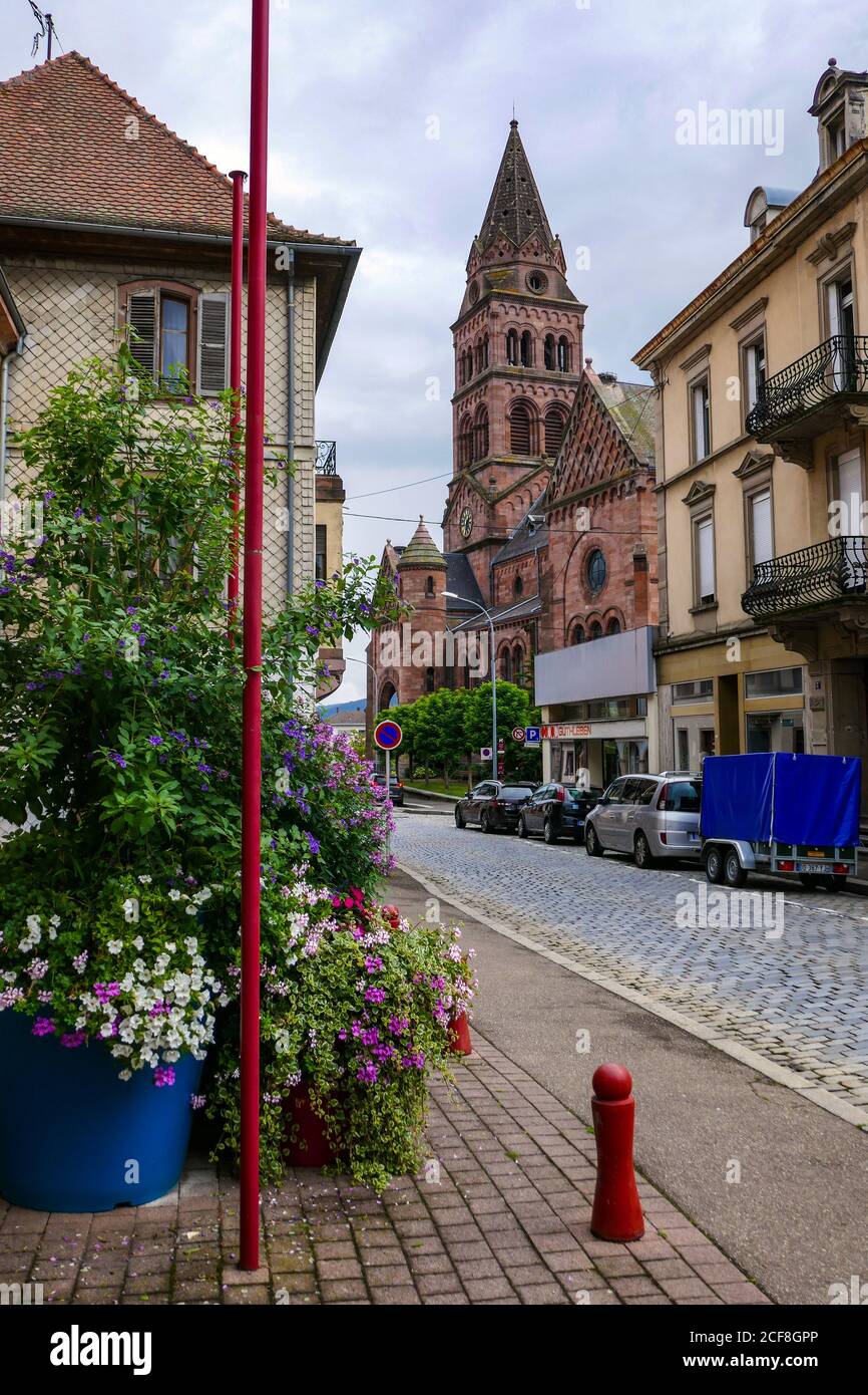 Big red sandstone church with tower, ihe old town of Munster, in the ...