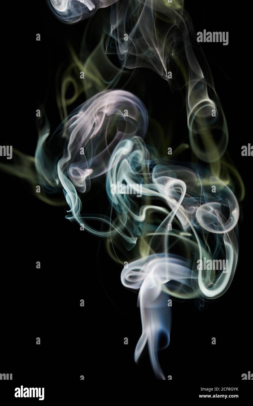 Abstract colorful smoke swirl with smooth shape in black background ...