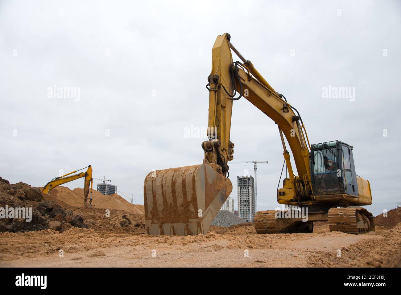 Track-type excavator during earthmoving at construction site. Backhoe ...