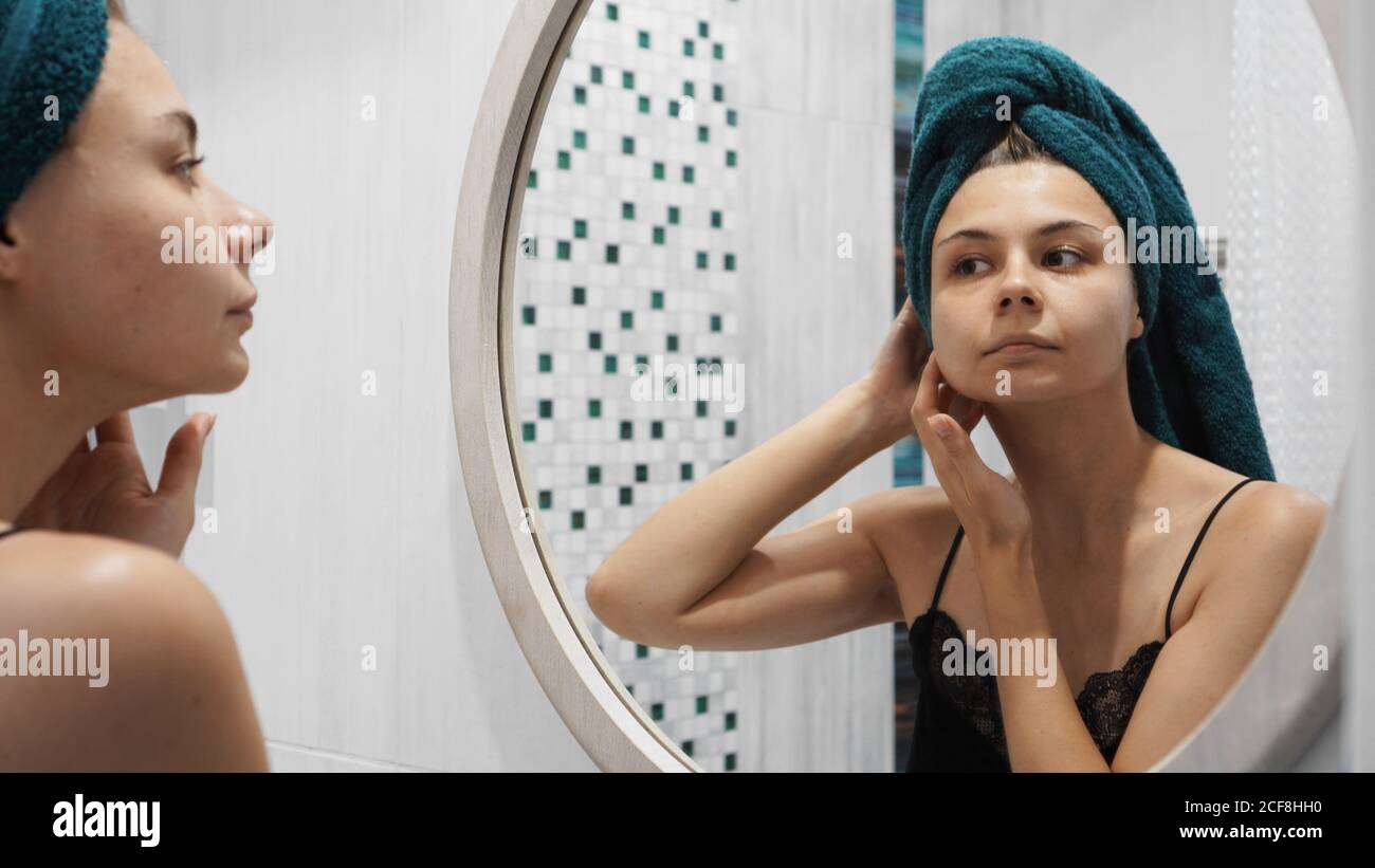 Young woman has problems with skin on the face - She looks in the ...