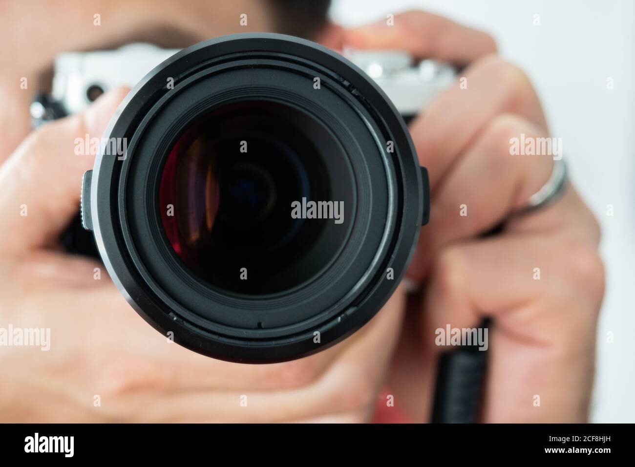 Man taking a photo holding a camera horizontally Stock Photo - Alamy