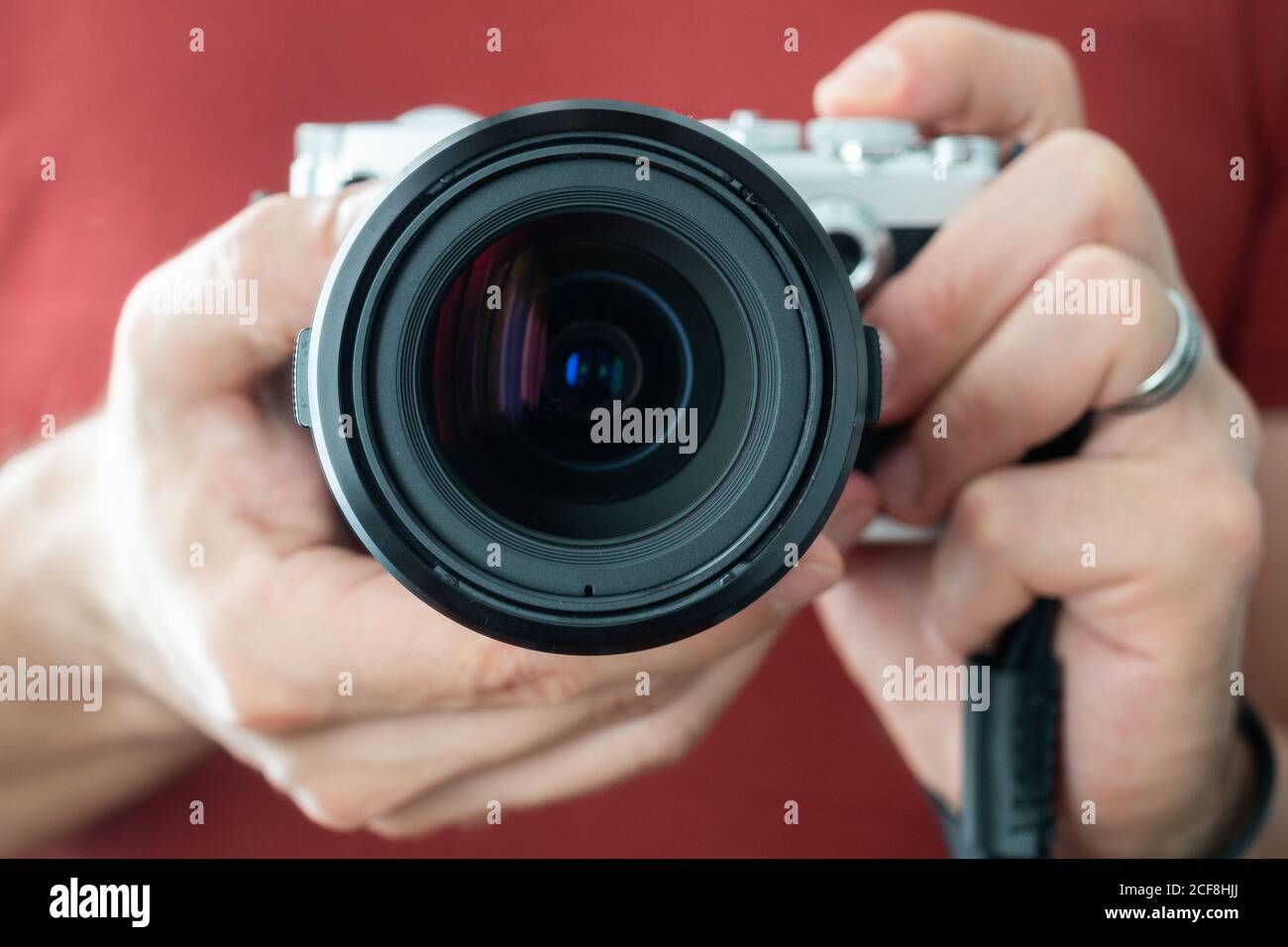 Camera held by a man horizontally Stock Photo - Alamy