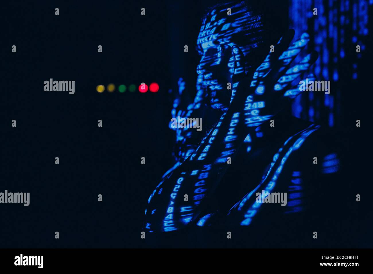 Young man with blue letters on his face in the dark Stock Photo - Alamy