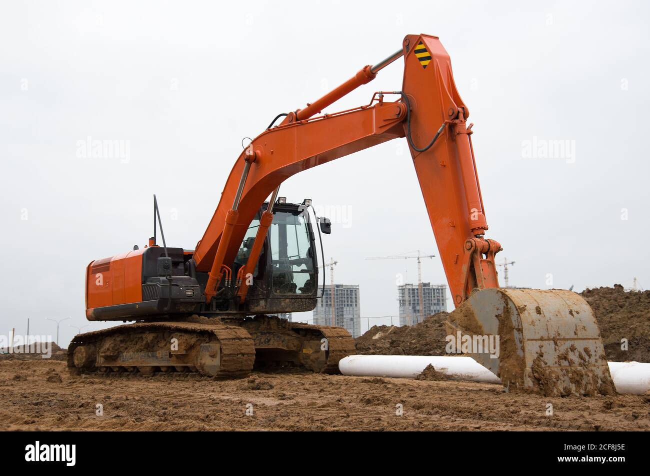 Excavator during earthworks at construction site. Backhoe digging the ...