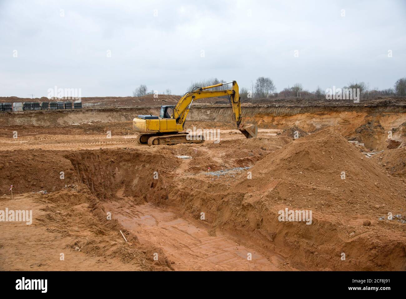 Excavator during earthworks at construction site. Backhoe digging the ...