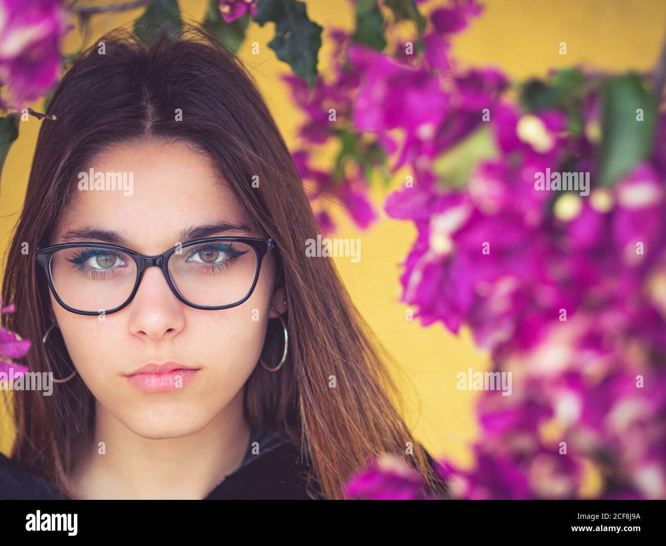 Woman on background of stunning violet flowers Stock Photo - Alamy