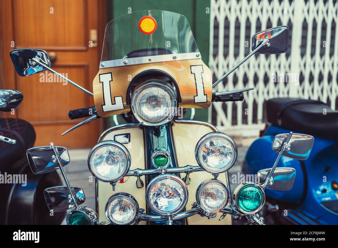 Shiny vintage motorcycles of various bright colors parked in row on ...