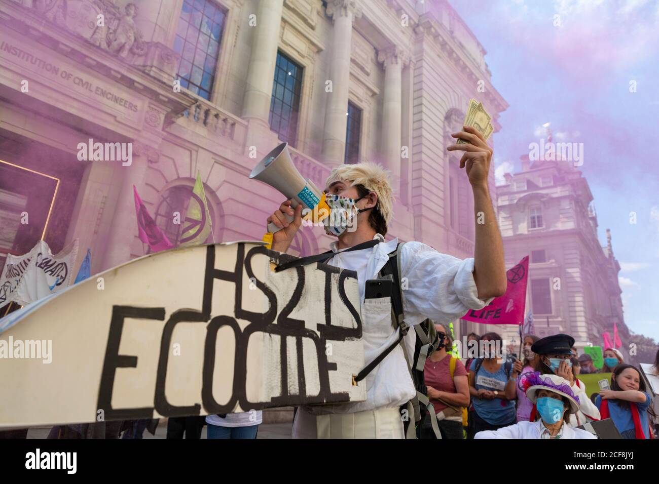 A protester speaking into a megaphone during Extinction Rebellion ...