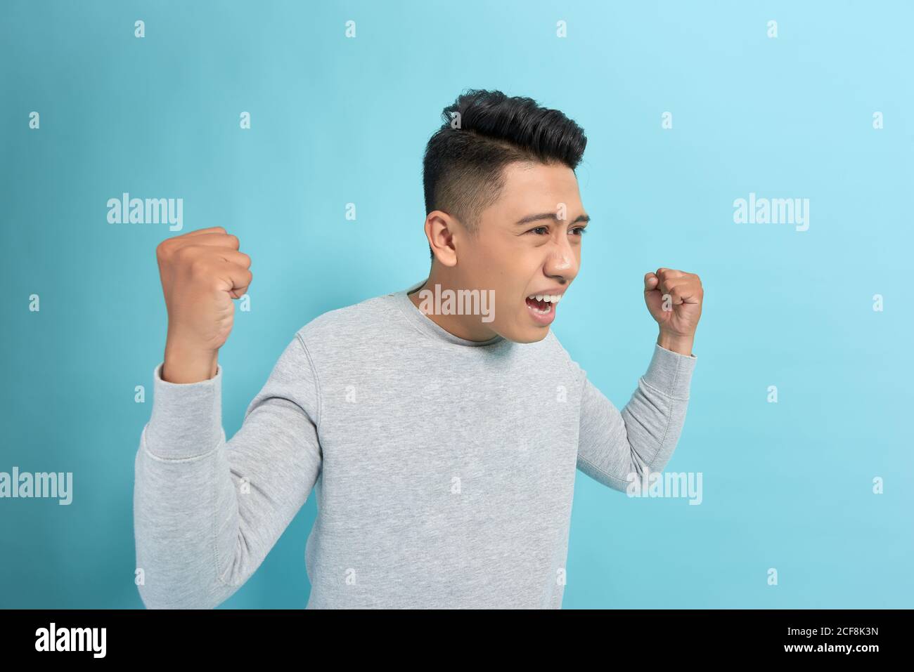 Excited businessman celebrating a win Stock Photo - Alamy
