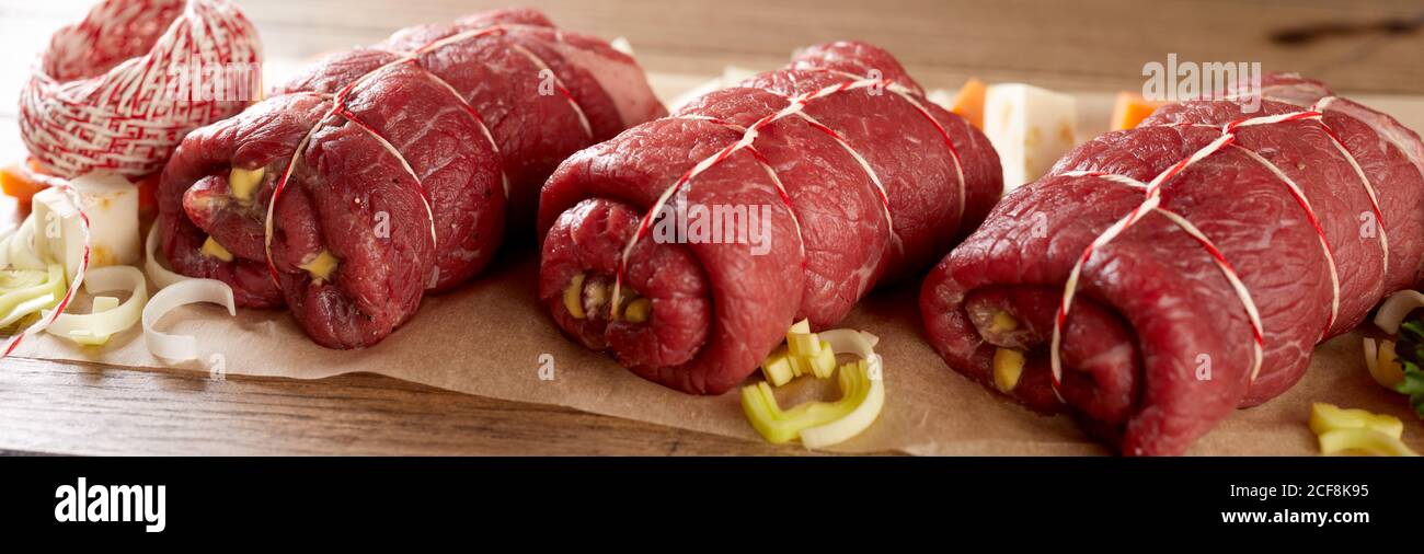 Prepared raw beef roulades with pickle and bacon ready for cooking in ...