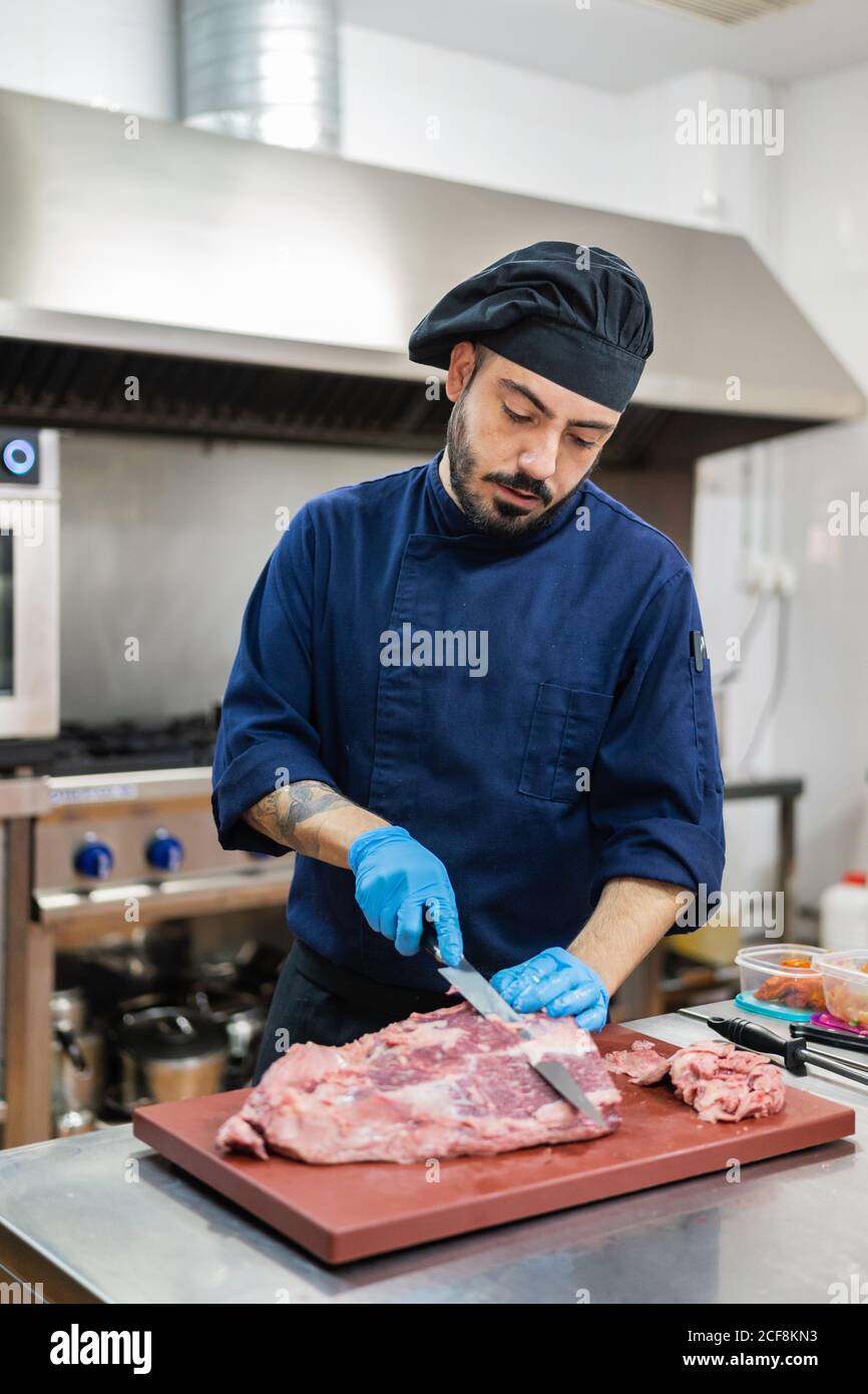 Professional chef cutting fresh meat hi-res stock photography and ...