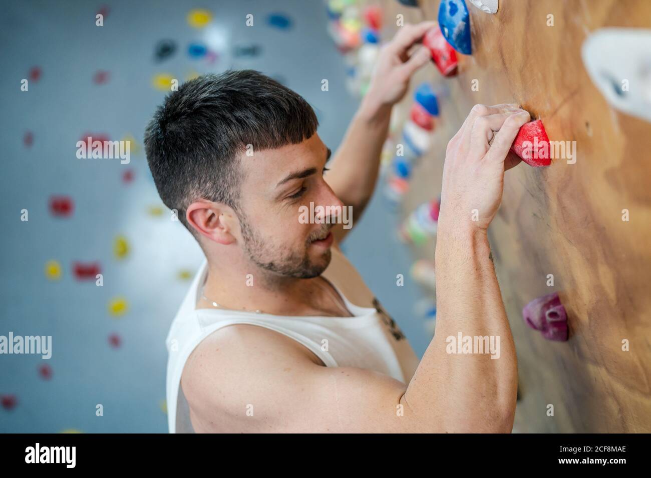 Side view of man climbing wall hi-res stock photography and images - Alamy