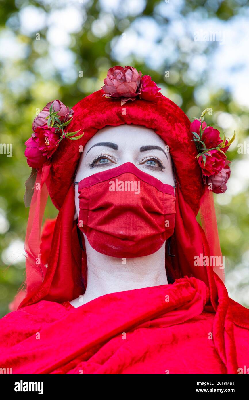 Portrait of a red-robed protester during Extinction Rebellion ...