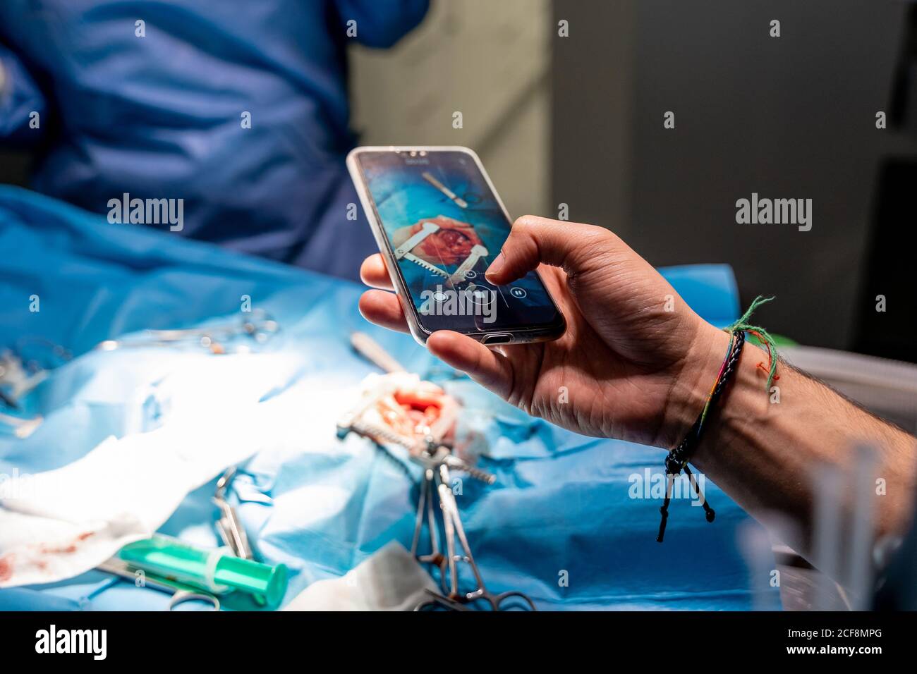 High angle crop male photographing with smartphone while focused ...