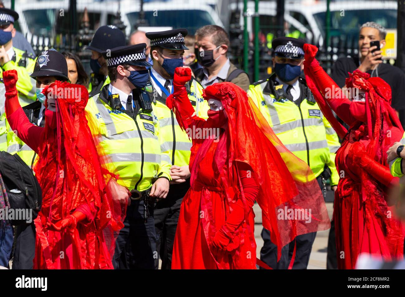 Red-robed protesters pass police during Extinction Rebellion ...