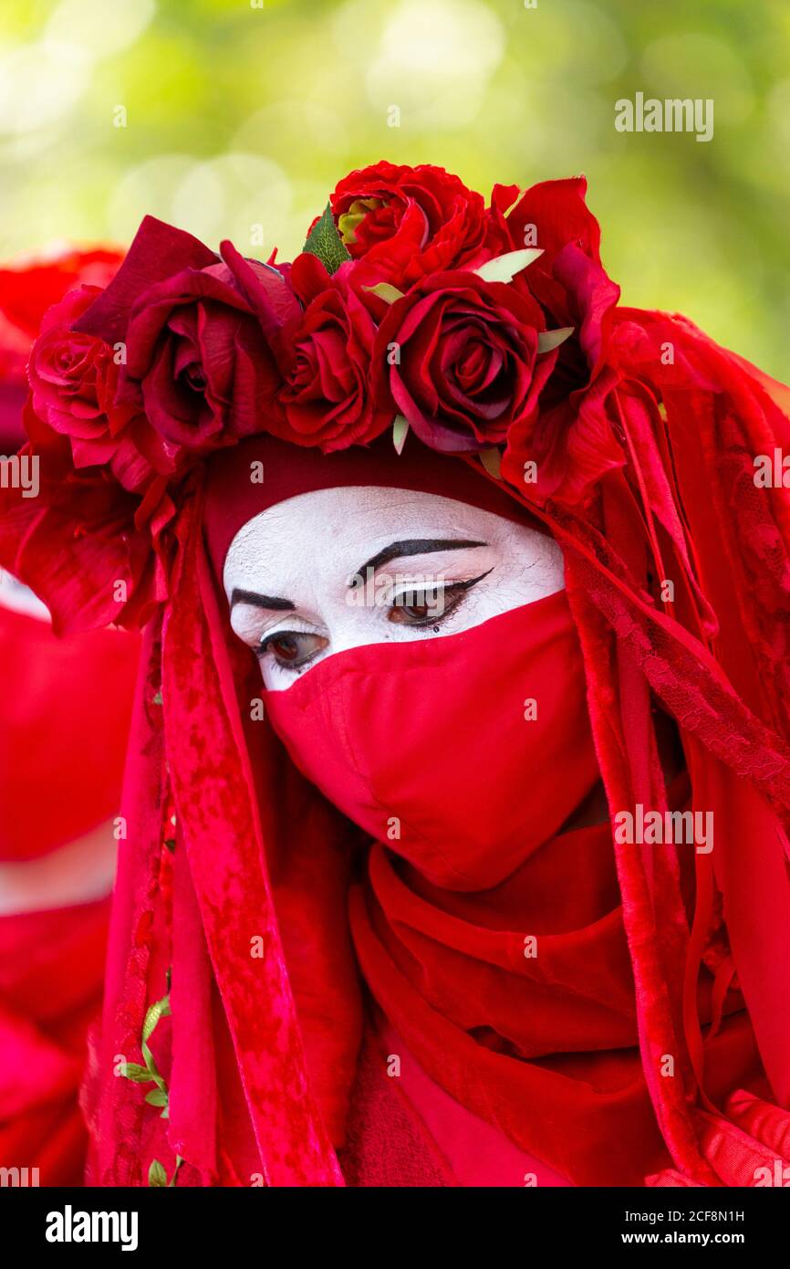Portrait of a red-robed protester during Extinction Rebellion ...