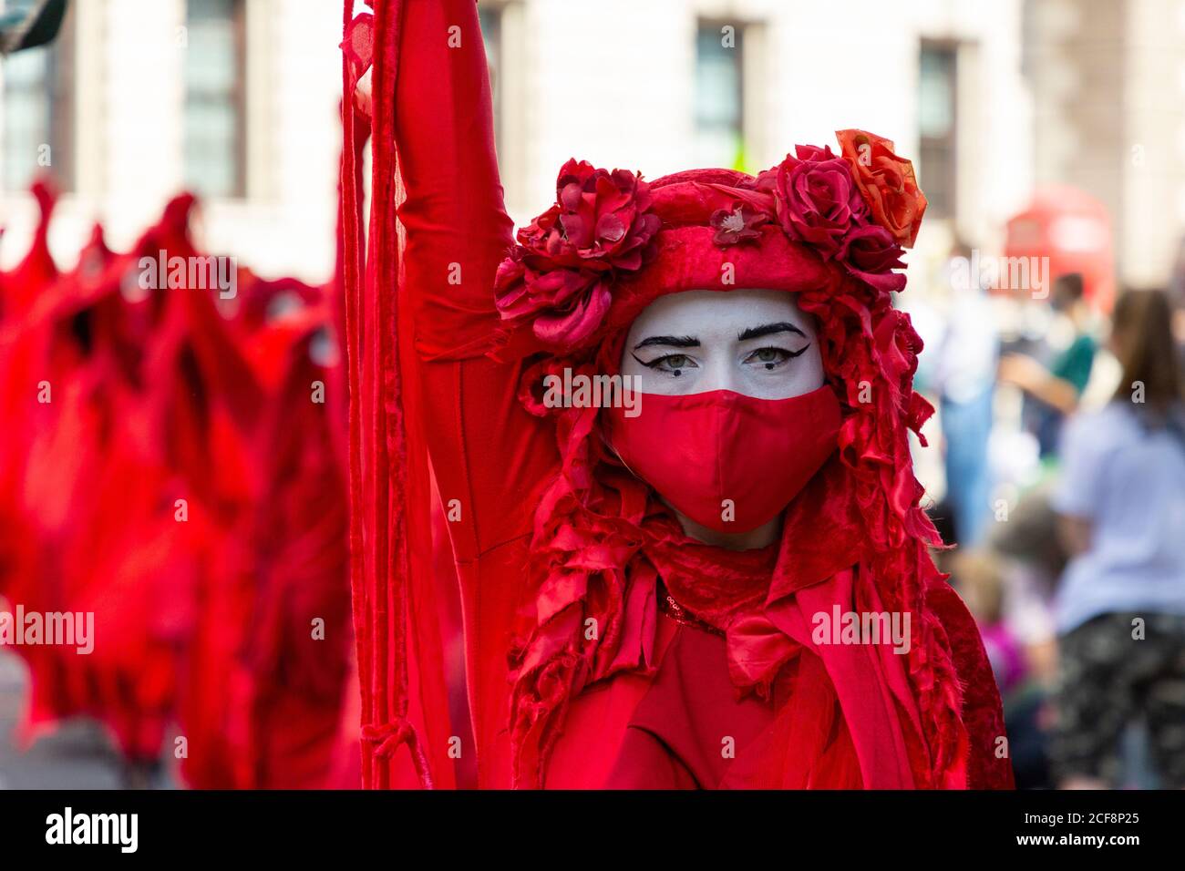Portrait of a red-robed protester during Extinction Rebellion ...